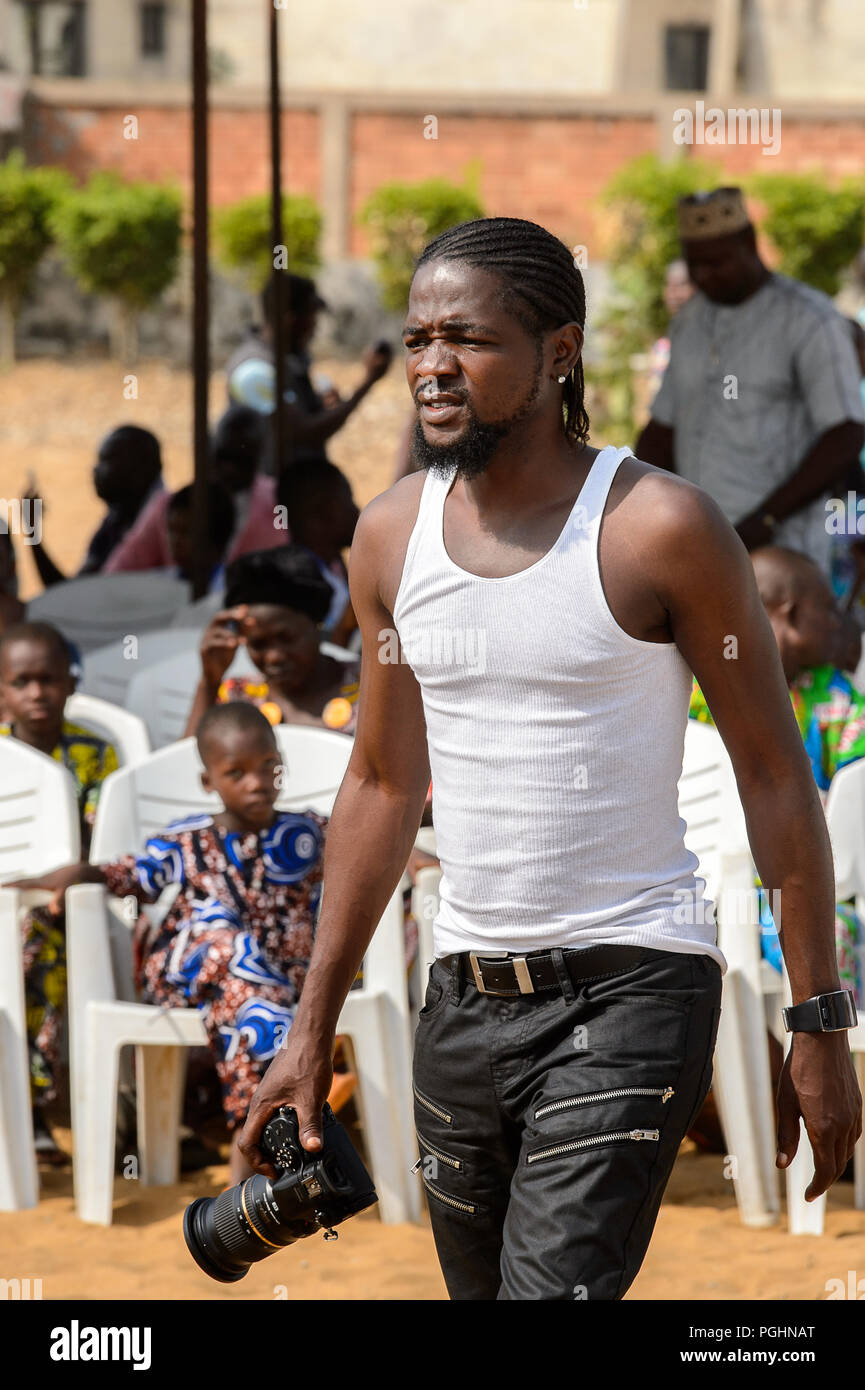 OUIDAH, BENIN - Jan 10, 2017: Unidentified Beninese man in white shirt ...