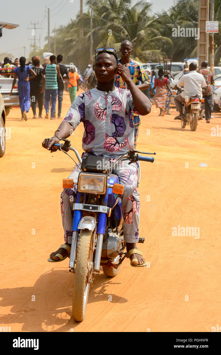 OUIDAH, BENIN - Jan 10, 2017: Unidentified Beninese man in colored suit ...