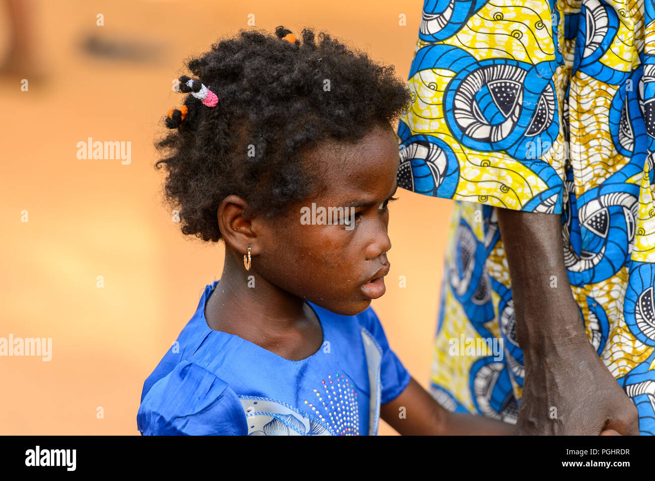 OUIDAH, BENIN - Jan 10, 2017: Unidentified Beninese little girl in blue ...