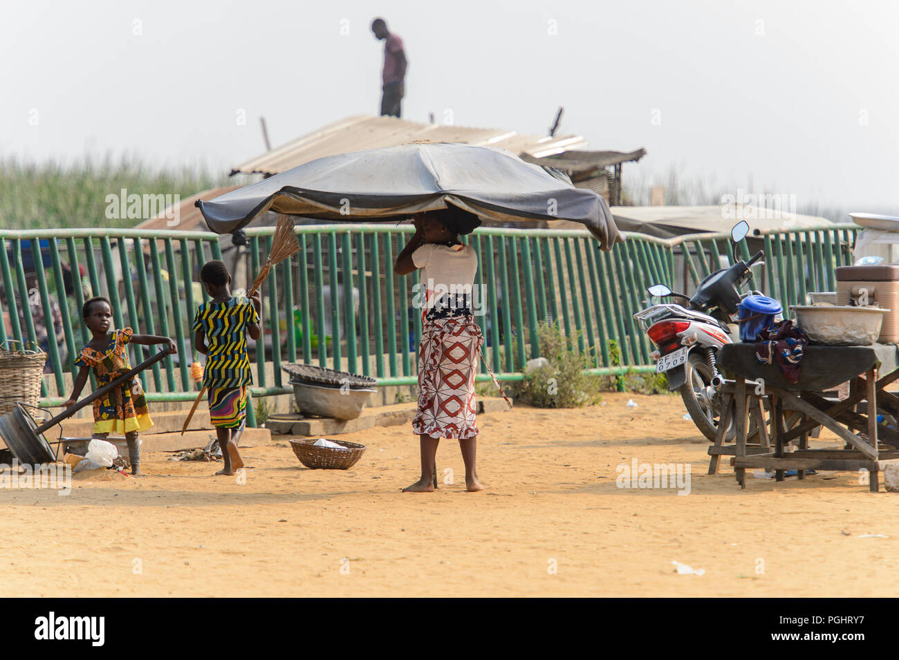 OUIDAH, BENIN - Jan 10, 2017: Unidentified Beninese woman hides from ...