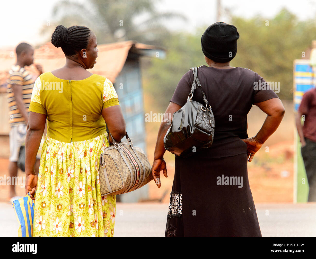 KUMASI, GHANA - Jan 16, 2017: Unidentified Ghanaian women in mustard ...