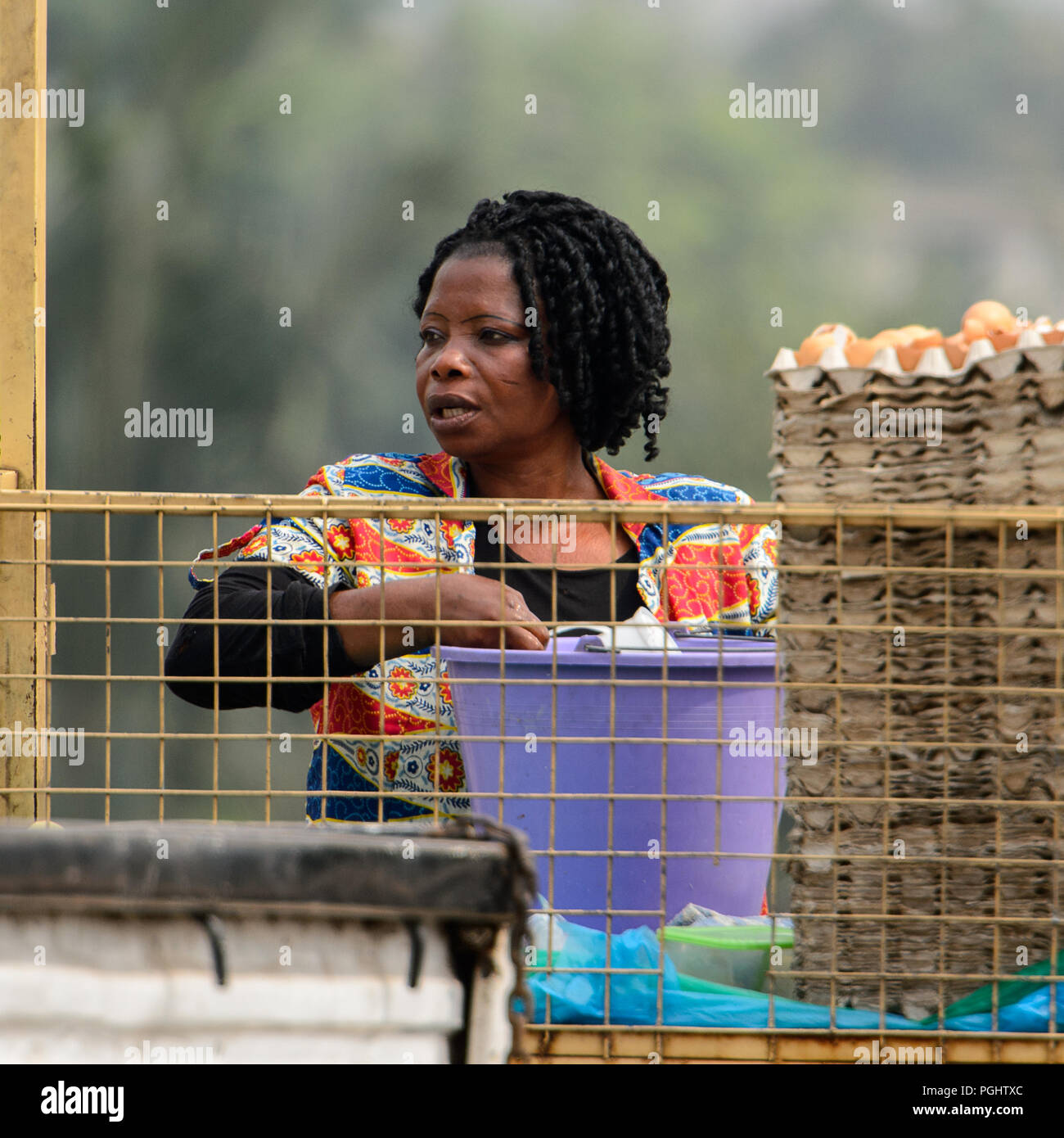 KUMASI, GHANA - Jan 16, 2017: Unidentified Ghanaian curly woman puts ...