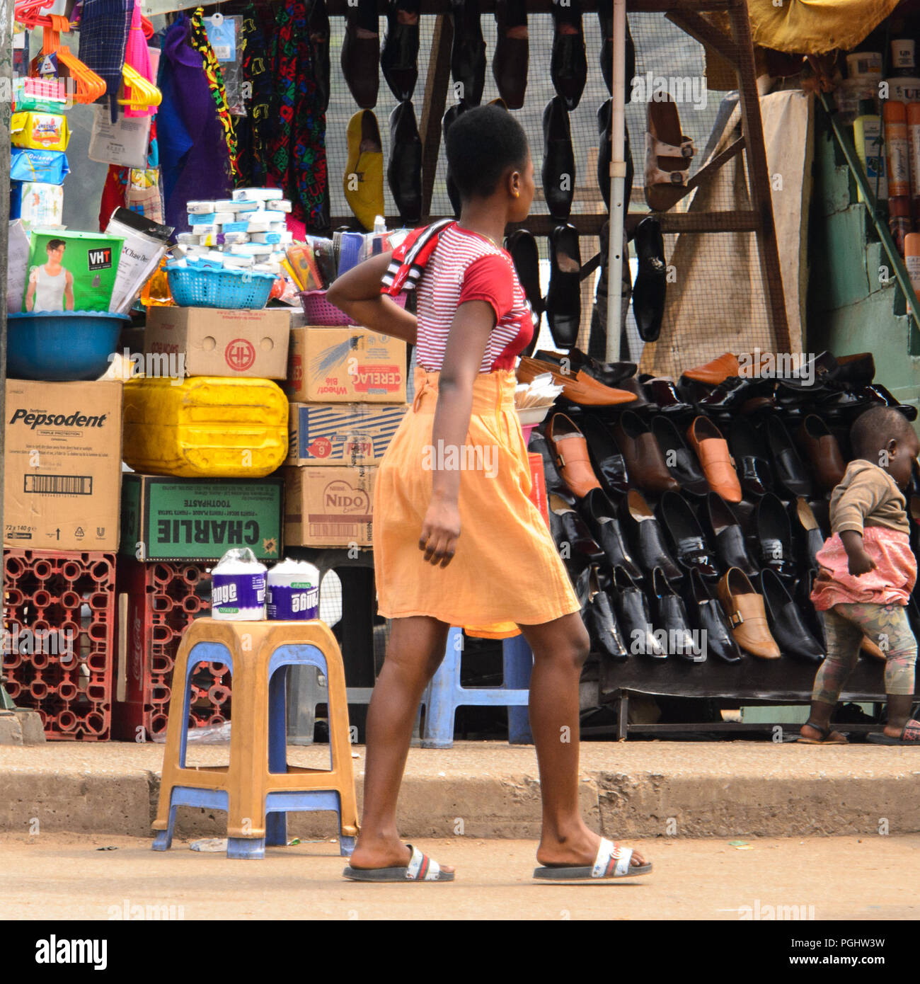 KUMASI, GHANA - Jan 16, 2017: Unidentified Ghanaian woman walks on the ...