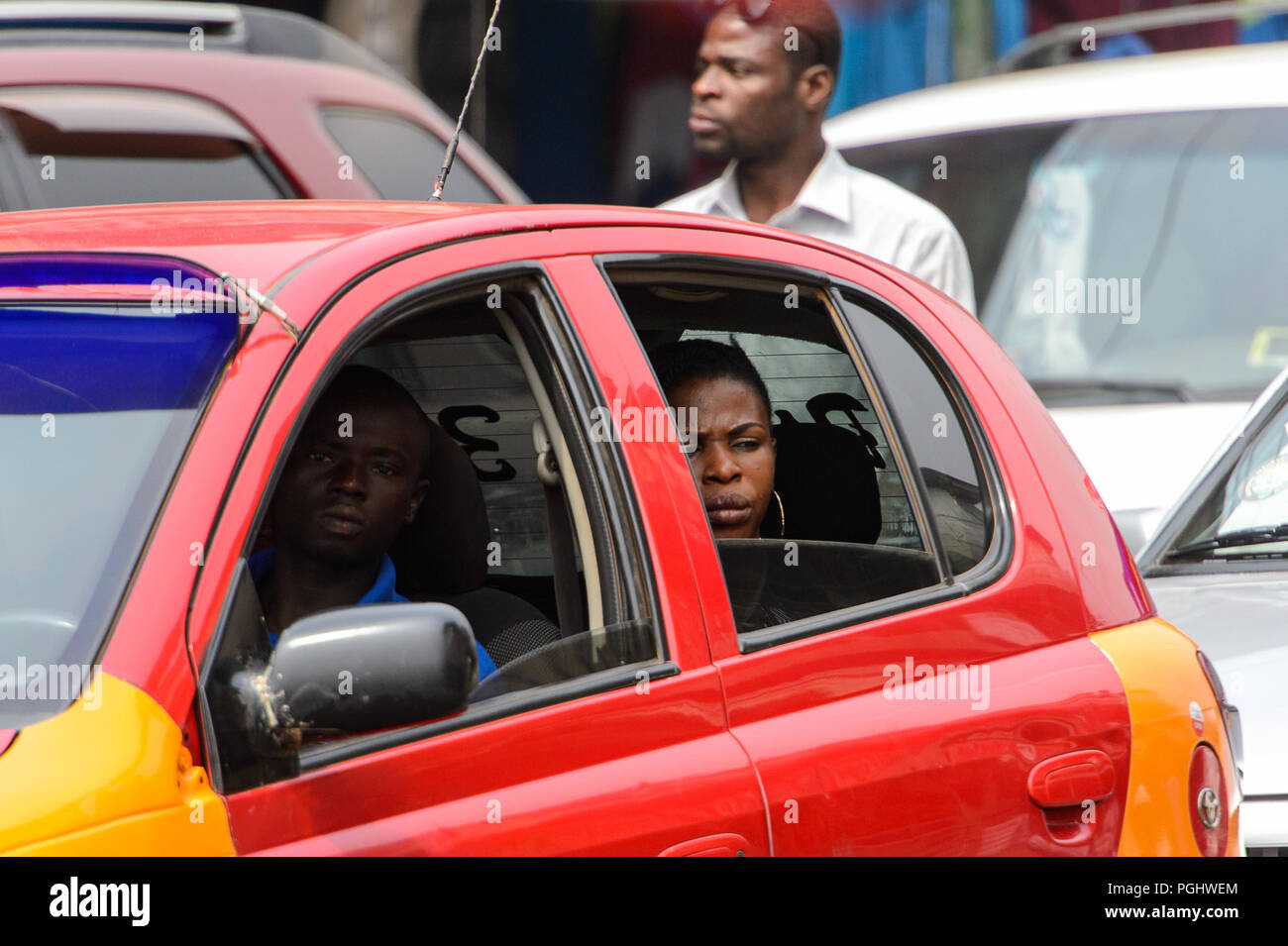 KUMASI, GHANA - Jan 16, 2017: Unidentified Ghanaian people drive on red ...
