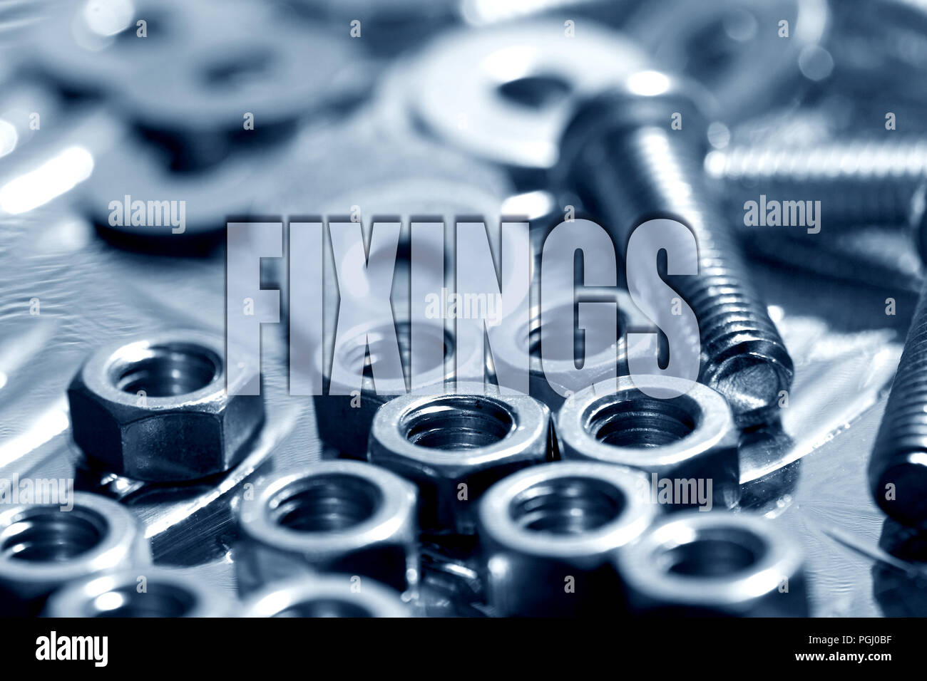 Fixings written on top of nuts and bolts in blue background Stock Photo ...