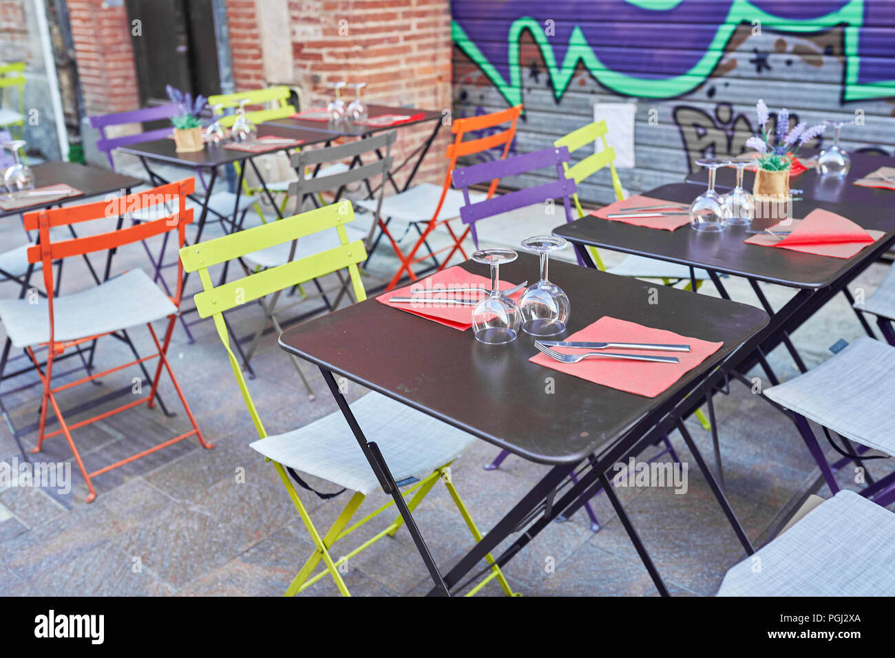 colorful tables on the terrace of a bar Stock Photo - Alamy