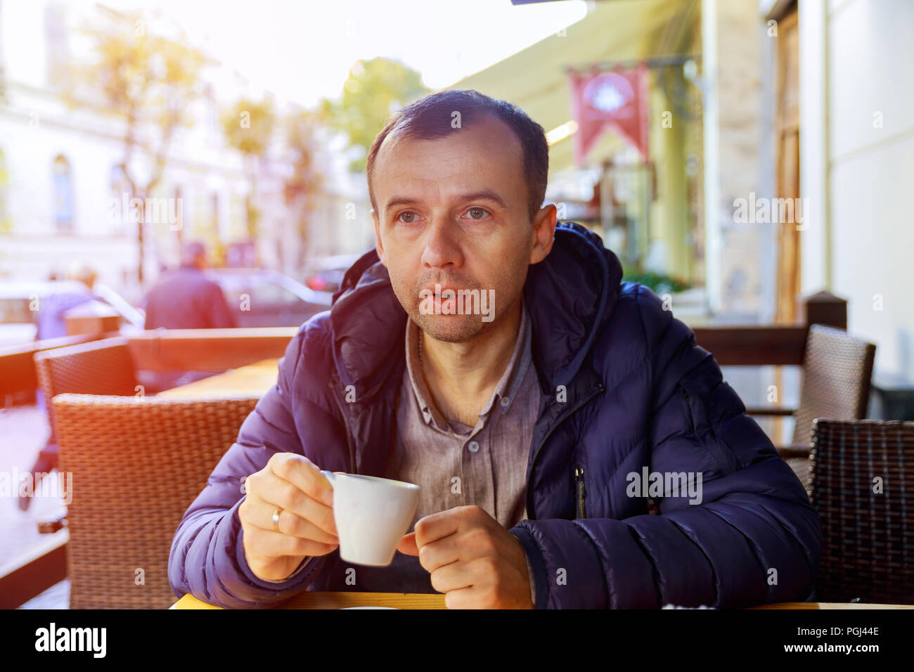 Man sitting in a cafe on a espresso coffee break on the street outdoor ...