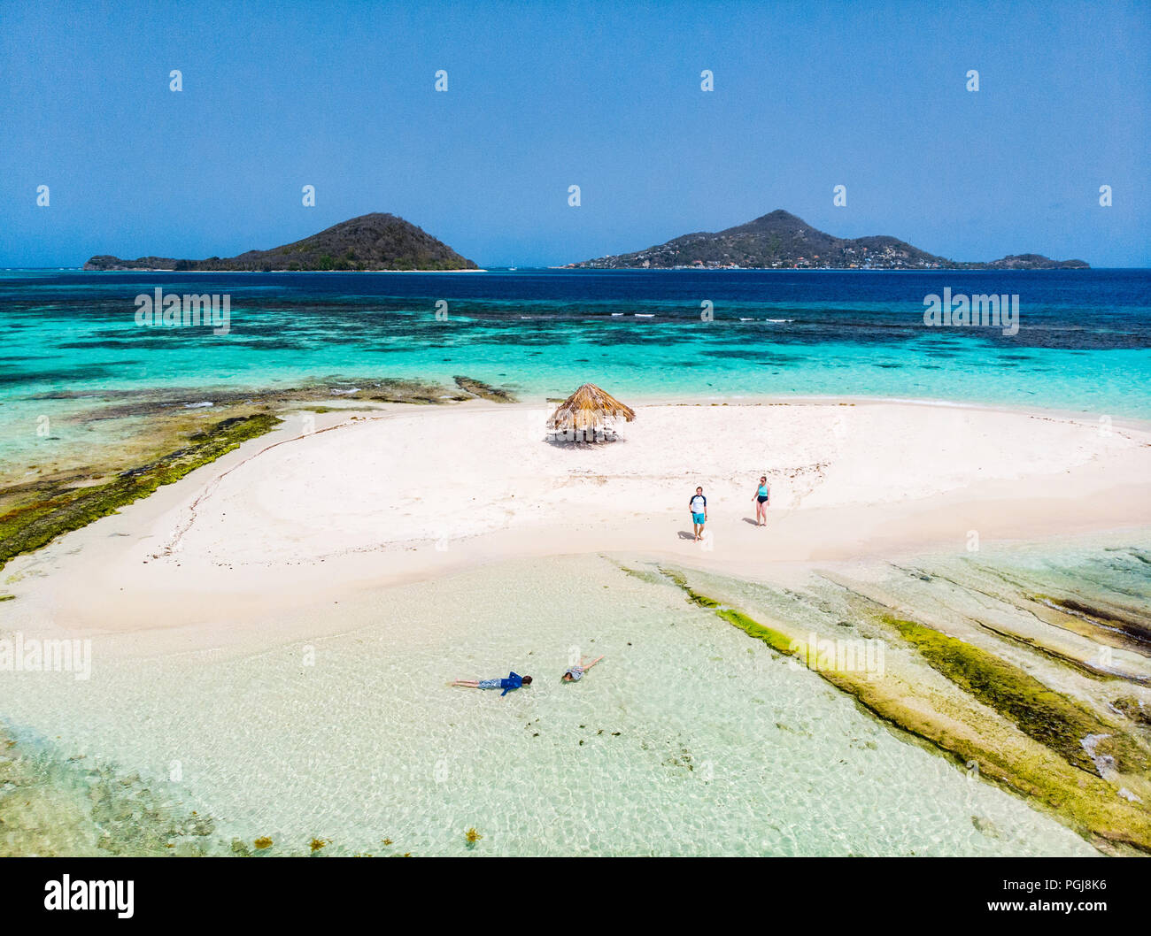 Aerial drone view of tiny tropical Mopion island sandbar, turquoise ...