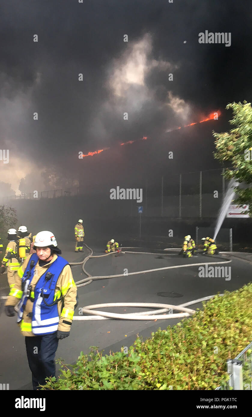 Aachen, Germany. 27th Aug, 2018. Smoke rises in an industrial park ...