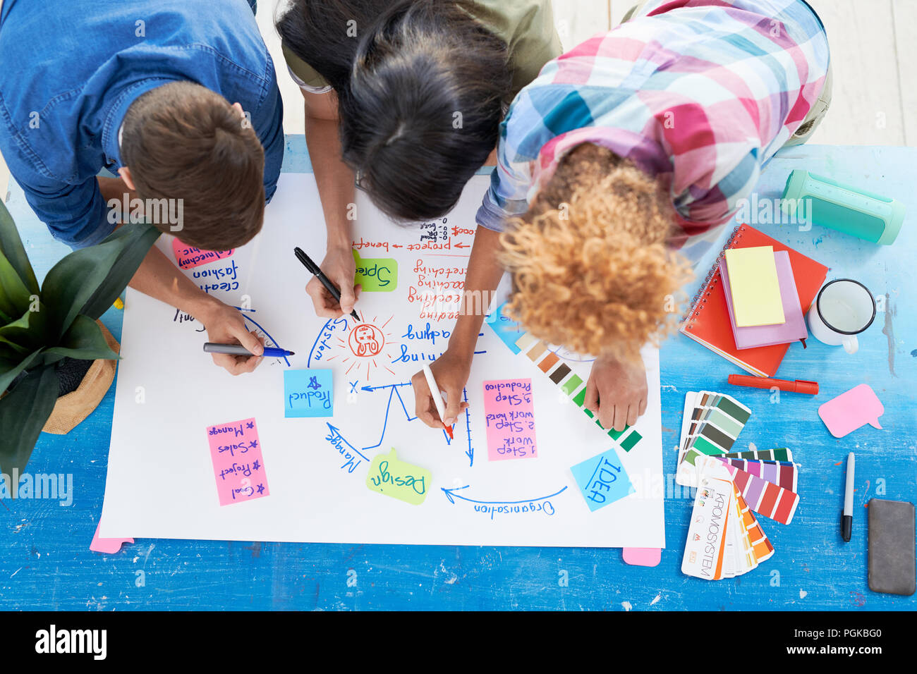 Above view at multi-ethnic group of cheerful young people drawing ...