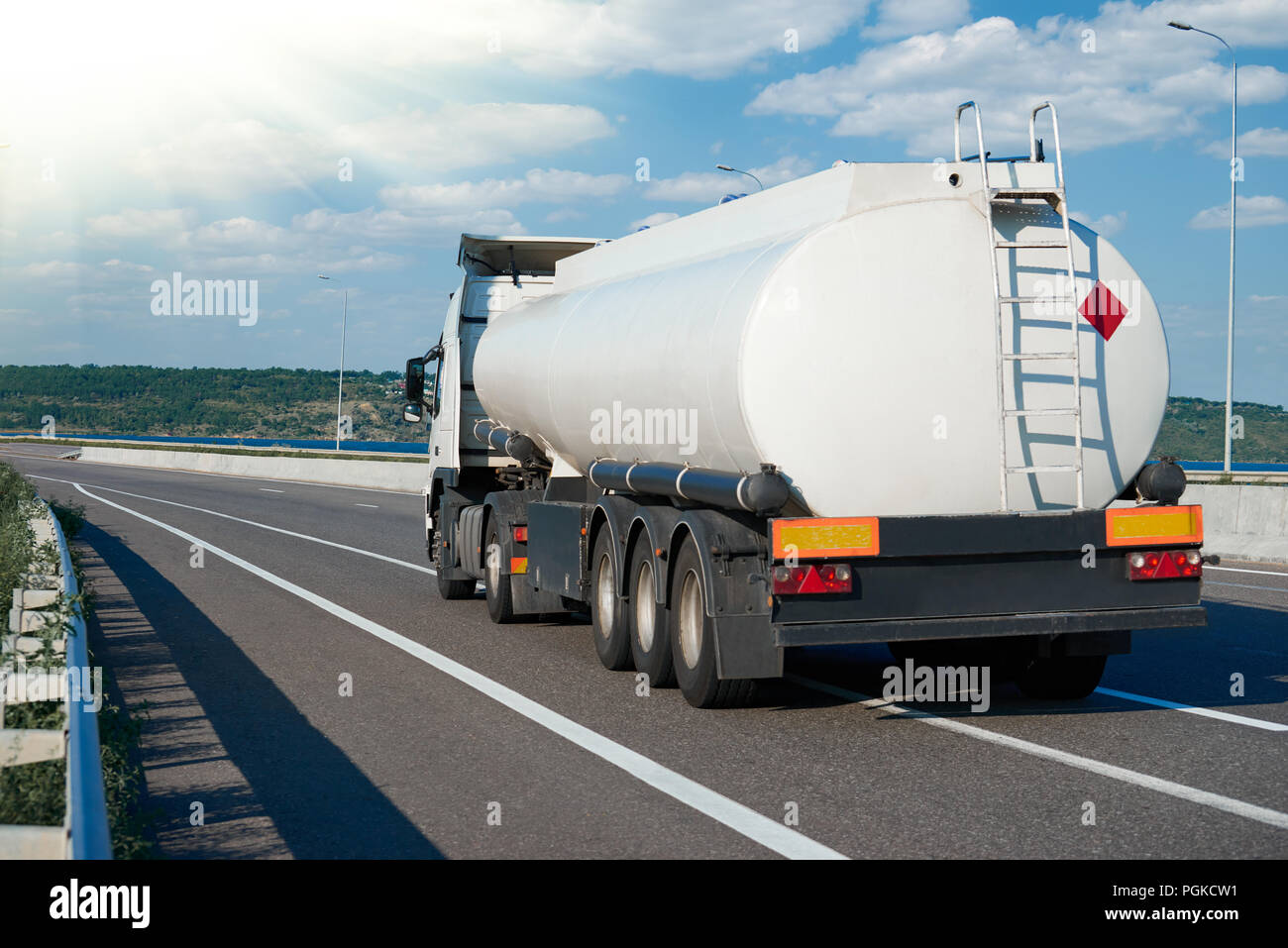 fuel truck rides on road, white blank color, rear view, one object on ...