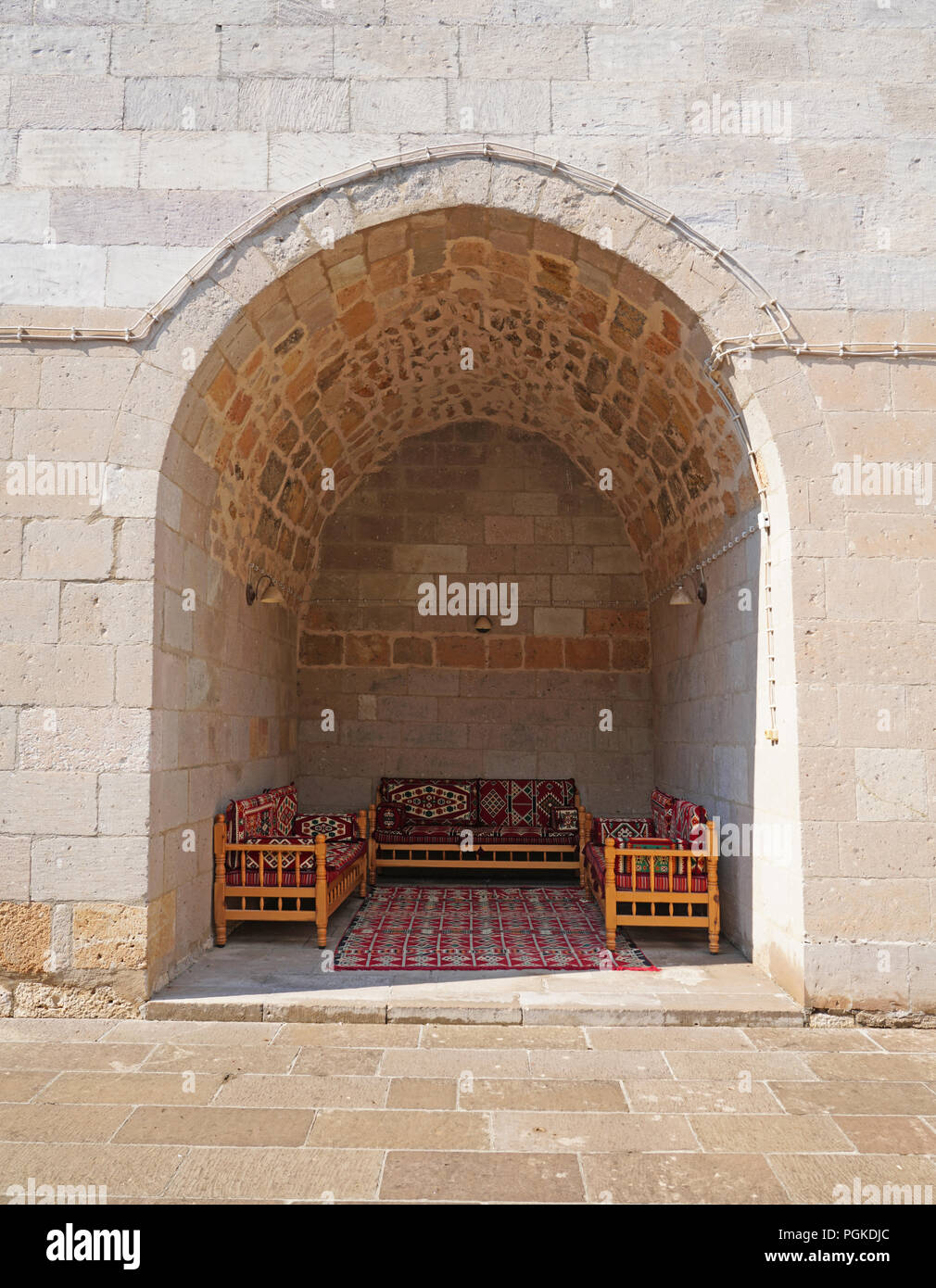 Interior design with oriental red rug furniture of an old stone room in ...