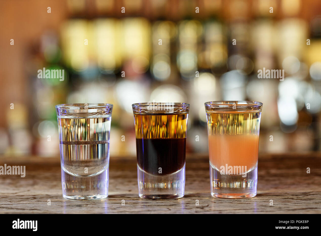 Different strong alcoholic cocktails shots in a nightclub on the bar ...