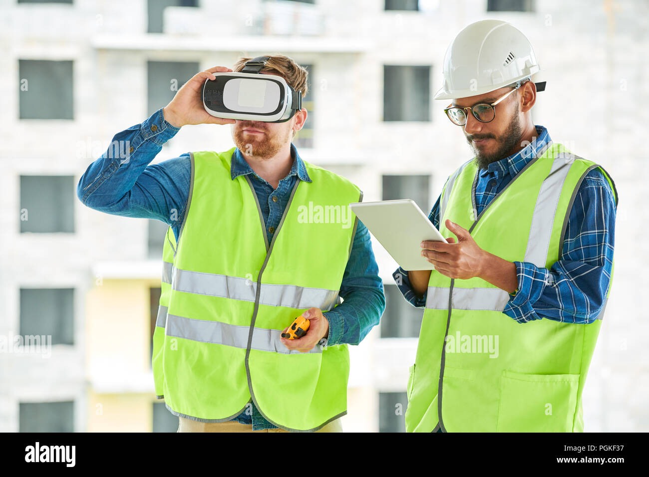 Waist up portrait of two contemporary workers using VR to visualize ...