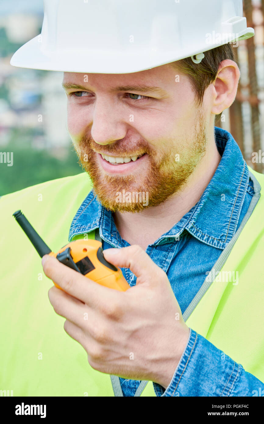 Head and shoulders portrait of bearded construction foreman speaking by ...
