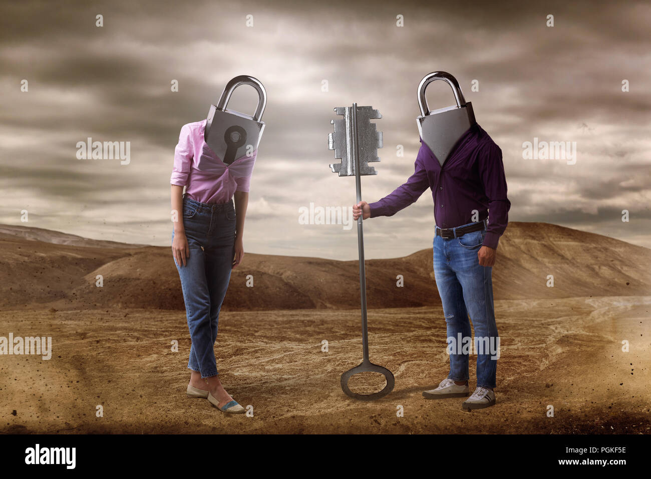 Man and woman with keyholes instead of heads holds big key, desert on ...