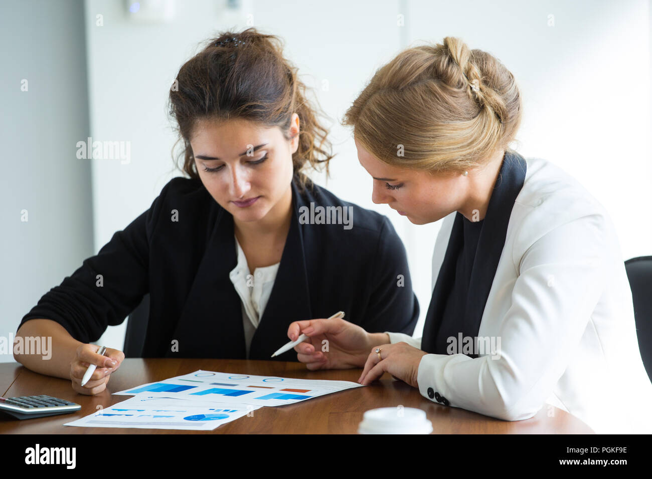 Business women working with financial diagrams, discussing financial ...