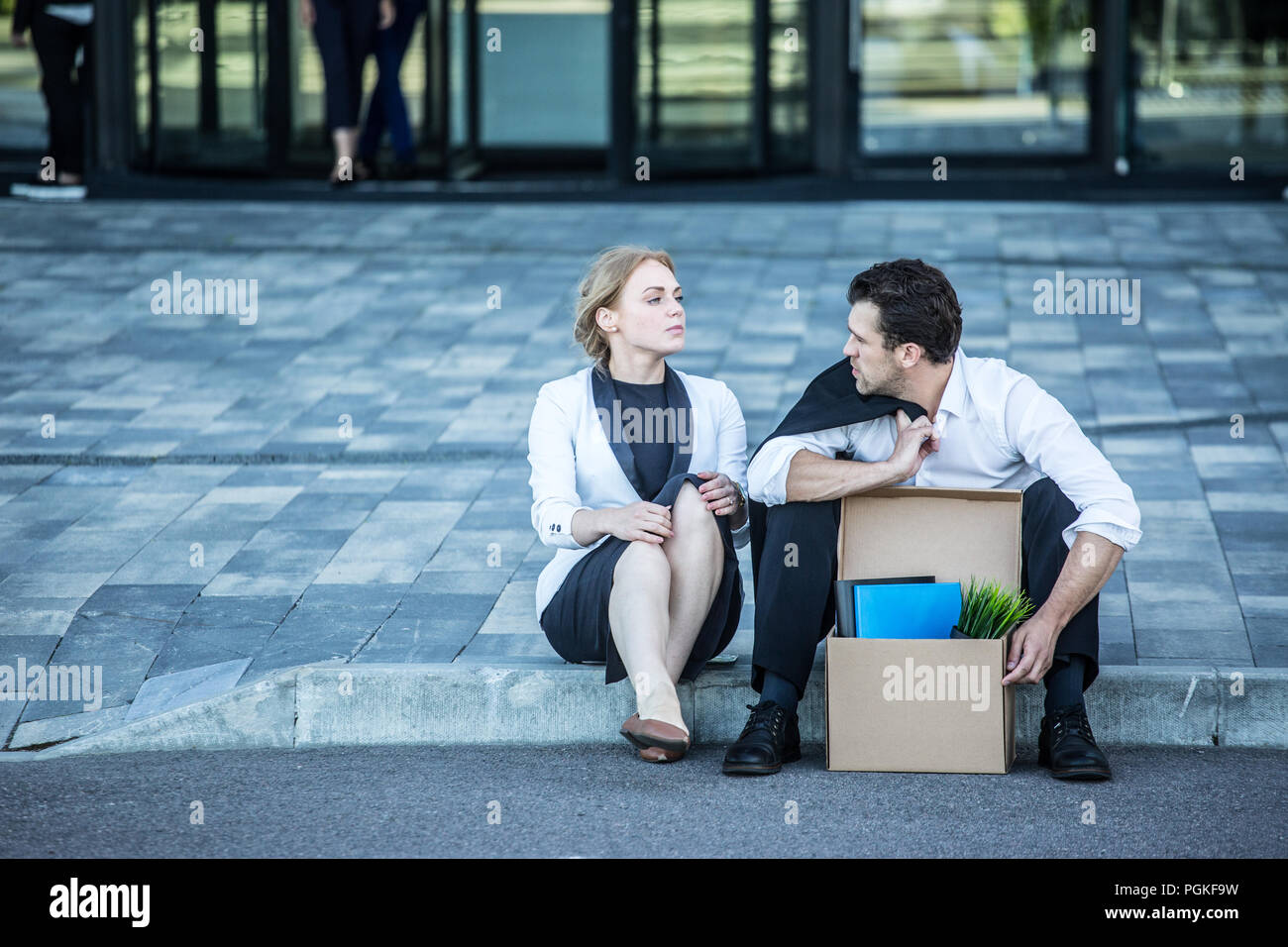 Fired business man sitting frustrated and upset on the street near ...