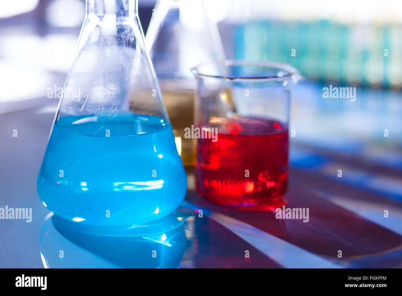 Backlit laboratory test flask containing colorful liquids Stock Photo ...