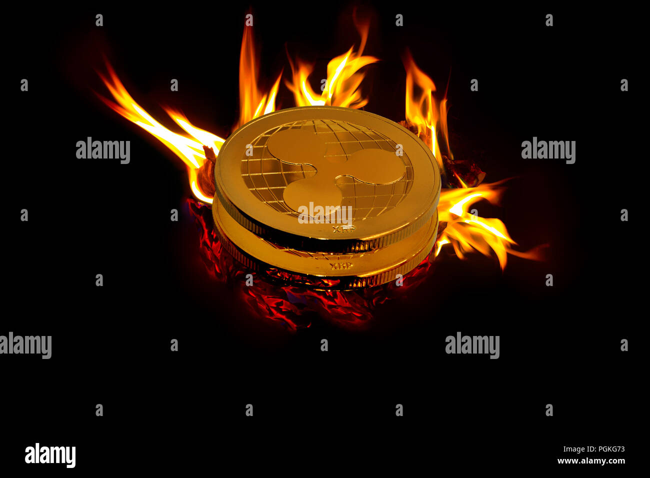 On a black background in open fire are the gold coins of a virtual ...