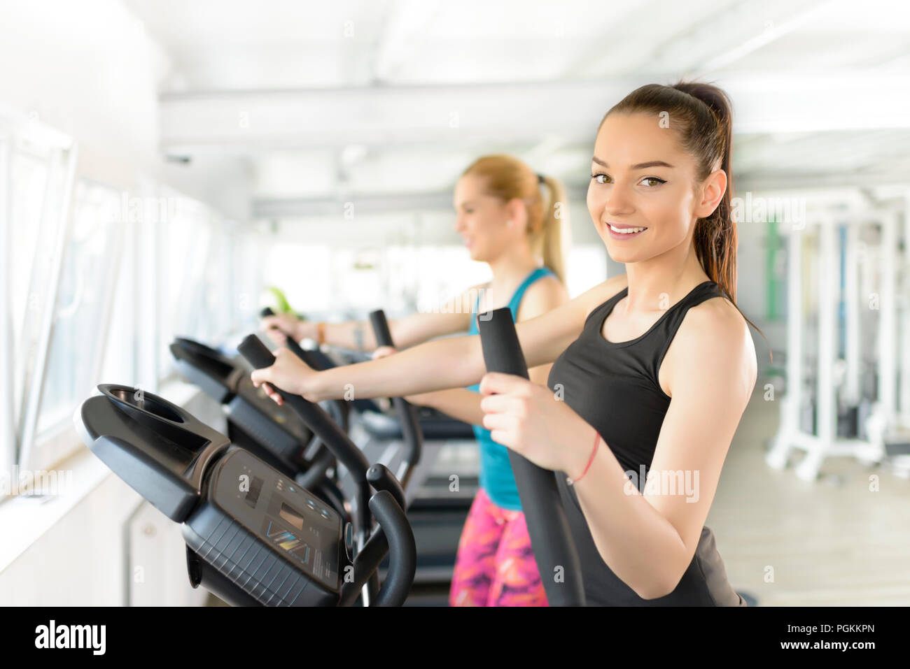 Lovely girl using stepper at gym Stock Photo - Alamy