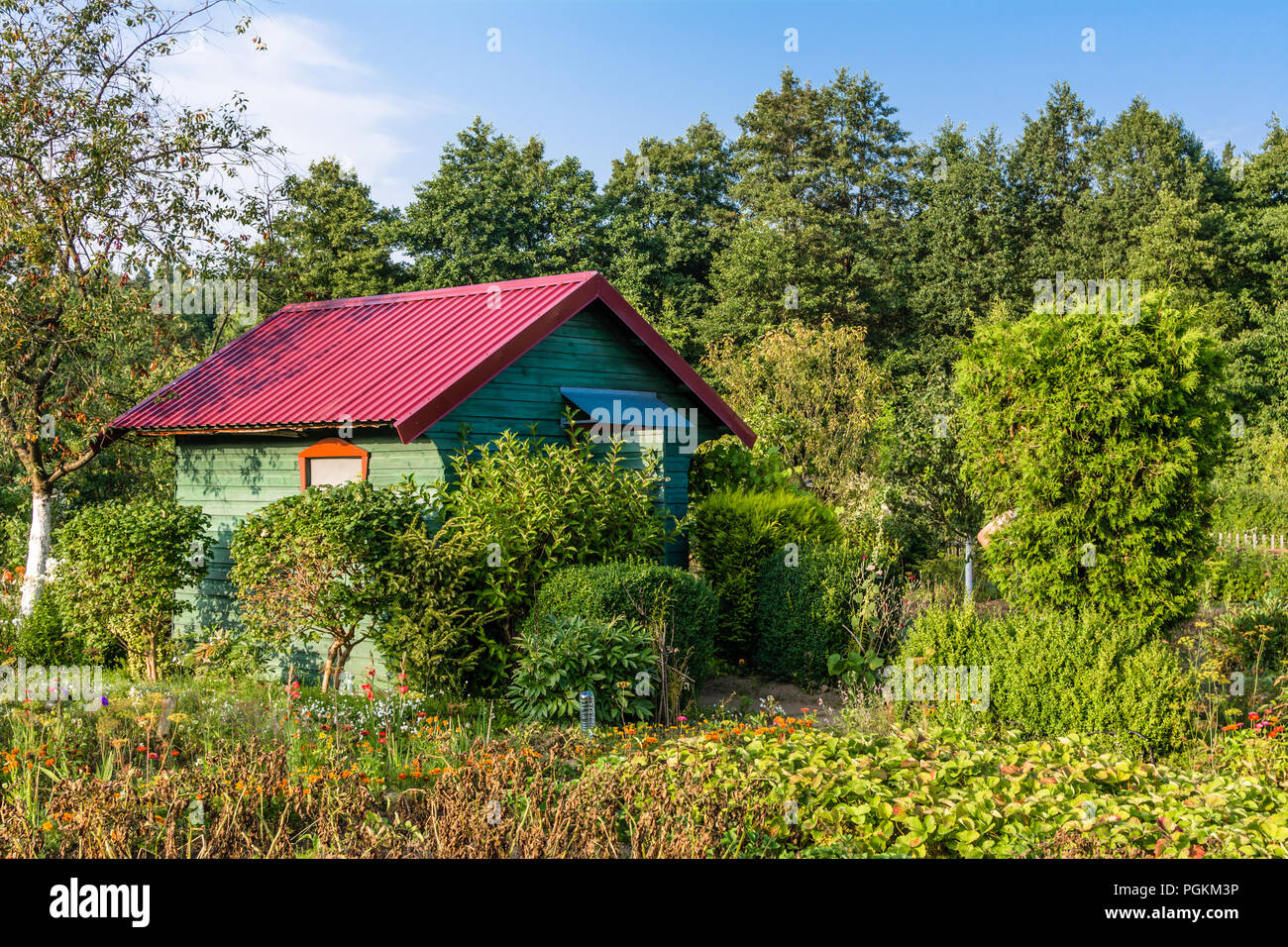 Wooden cottage in the garden in the summer countryside landscape Stock ...
