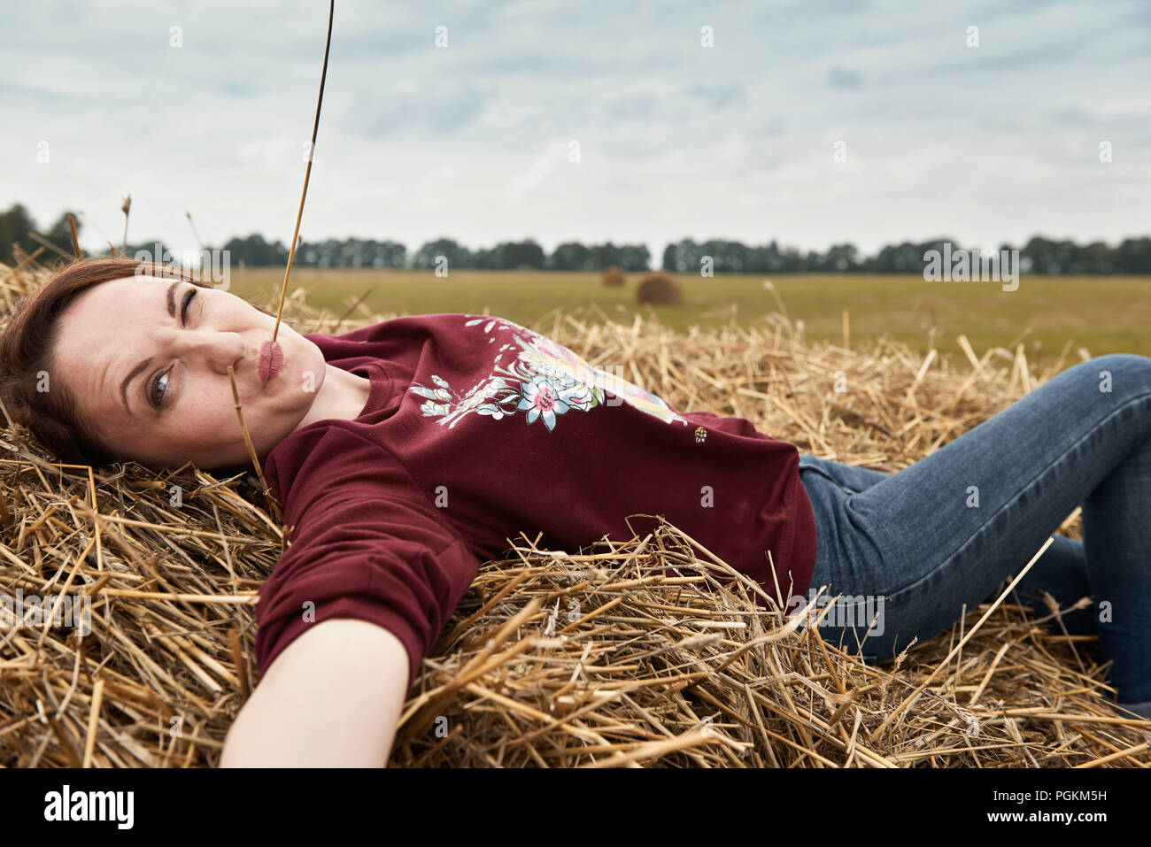 Girl lying on haystack hi-res stock photography and images - Alamy