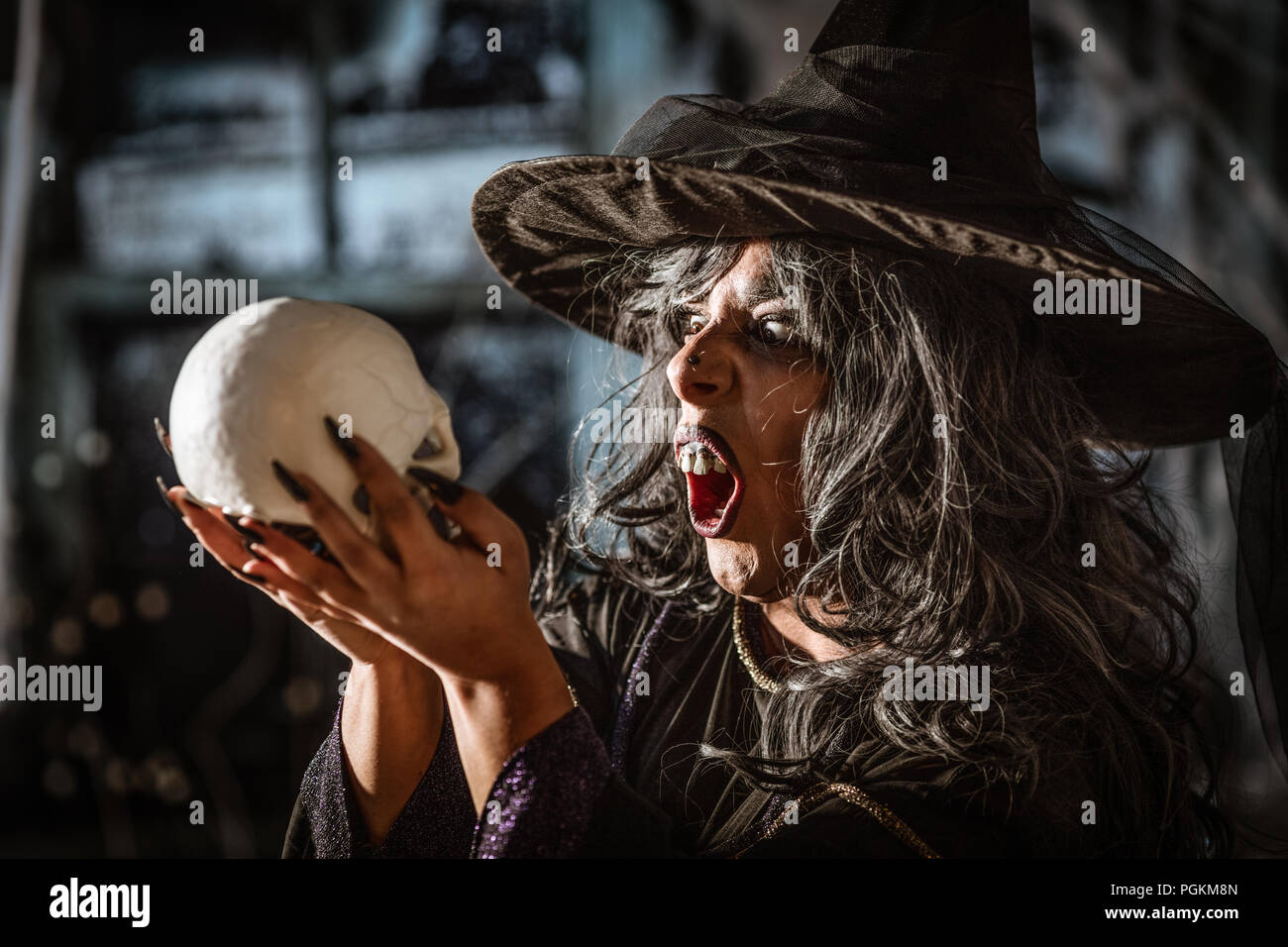 Portrait of witch with awfully face in creepy surroundings and smoky ...