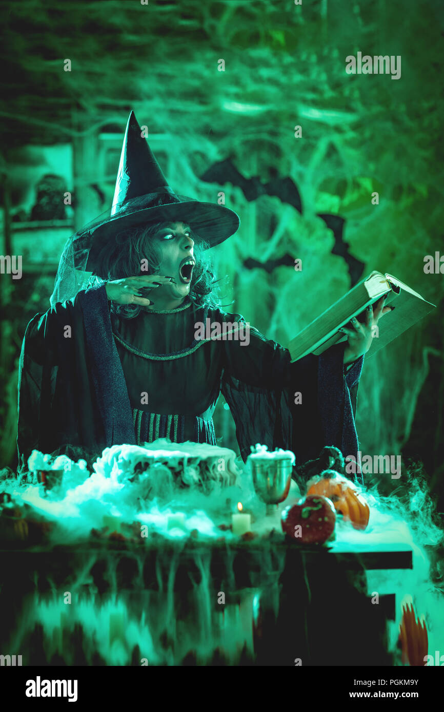 Witch with awfully face in creepy smoky green surroundings full of ...