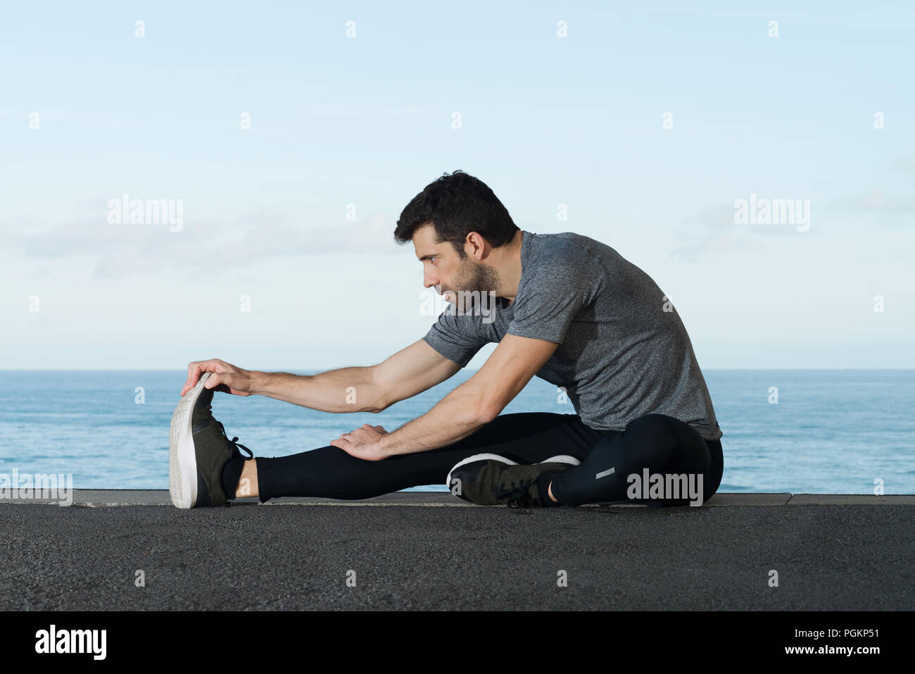 runner stretches leg space for text Stock Photo - Alamy
