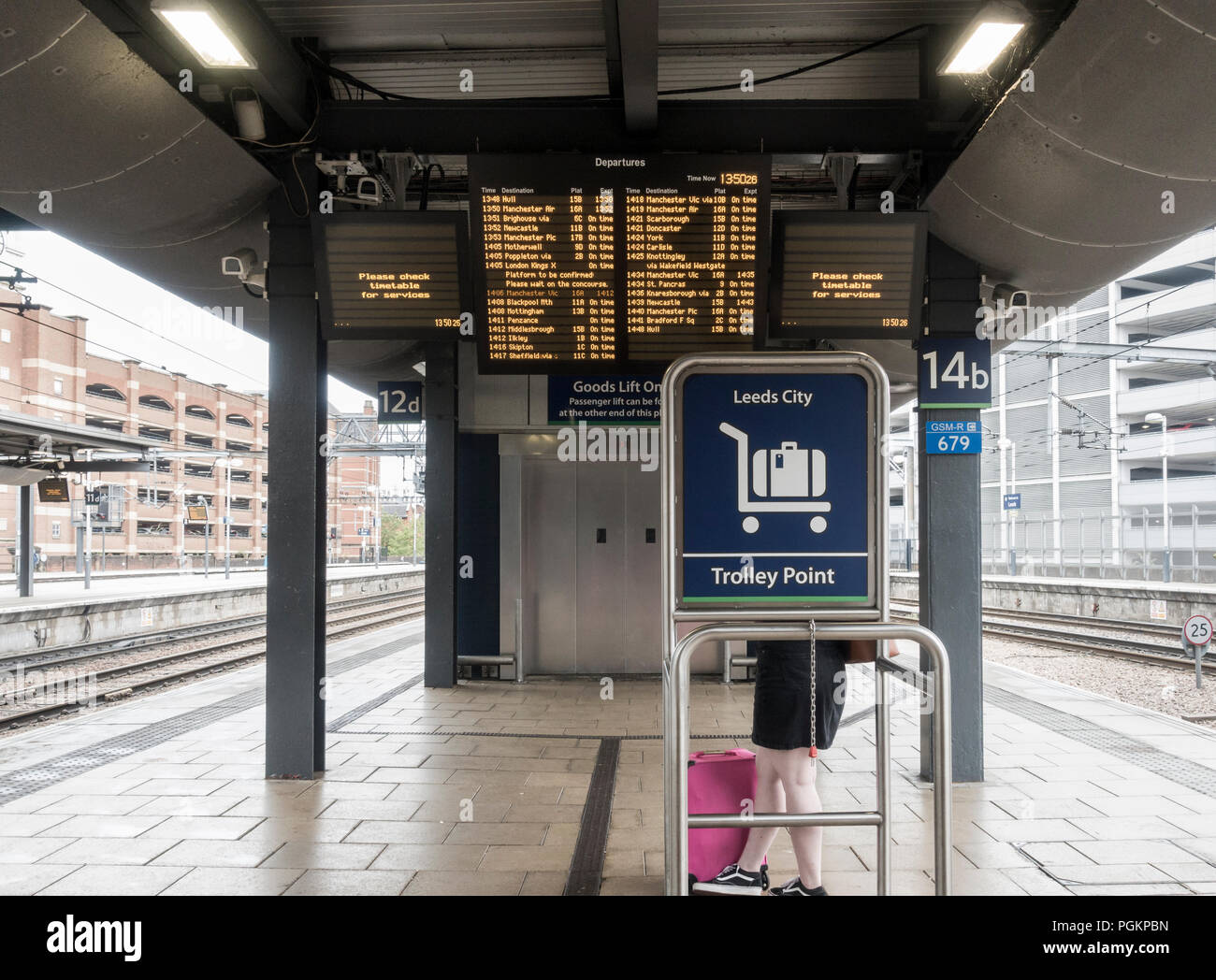 Woman on platform at Leeds train station, Leeds, West Yorkshire ...