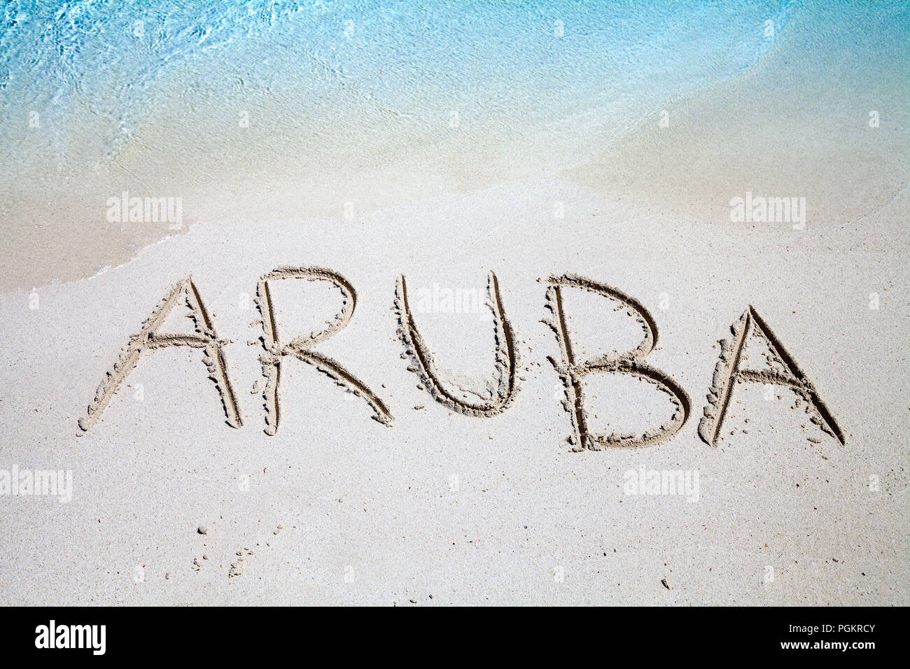 The inscription of Aruba on the beach of white sand Stock Photo - Alamy