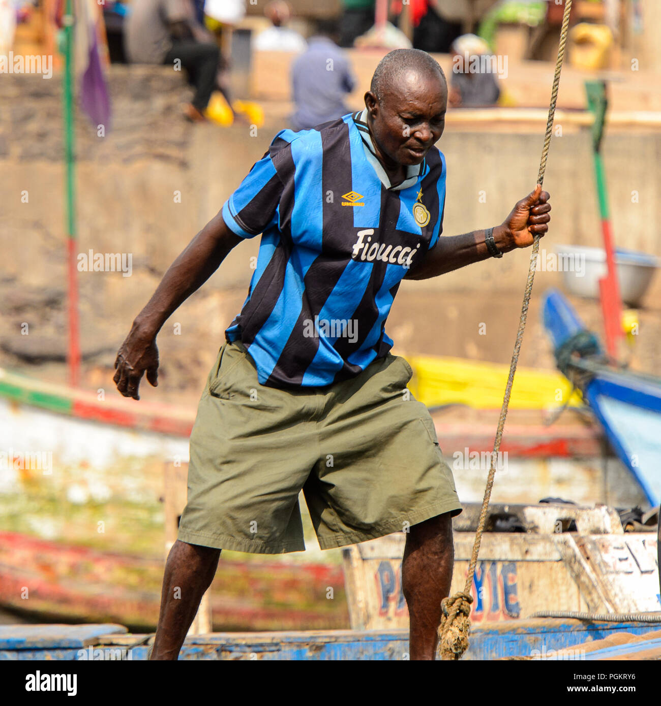 ELMINA, GHANA -JAN 18, 2017: Unidentified Ghanaian man in striped shirt ...