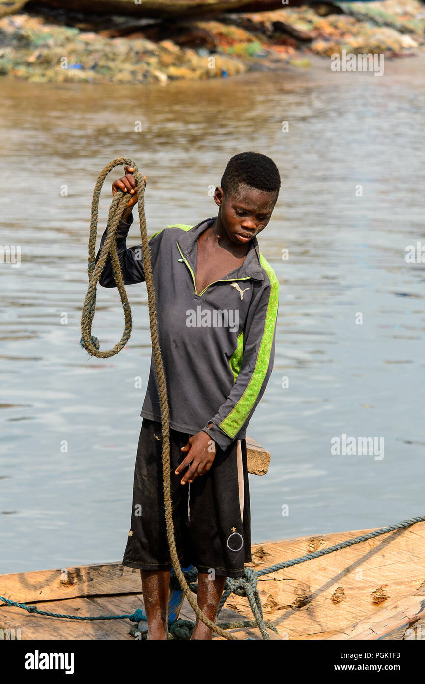 ELMINA, GHANA -JAN 18, 2017: Unidentified Ghanaian boy holds a rope on ...