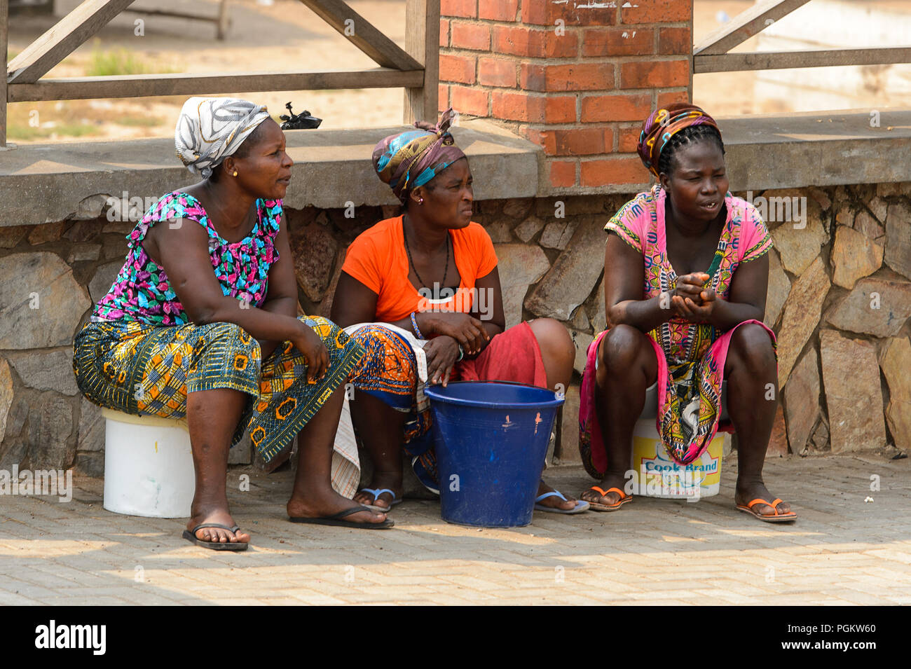 ELMINA, GHANA -JAN 18, 2017: Unidentified Ghanaian women sit on a ...