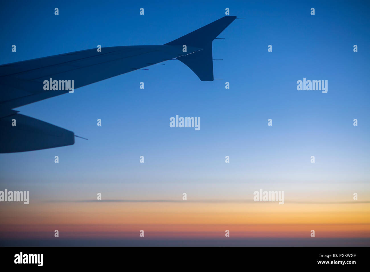 Wing of an airplane in the sunset. Airplane wing out of window Stock ...