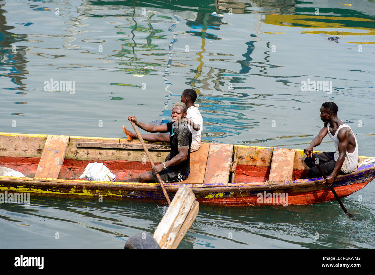 ELMINA, GHANA -JAN 18, 2017: Unidentified Ghanaian men sail on the boat ...