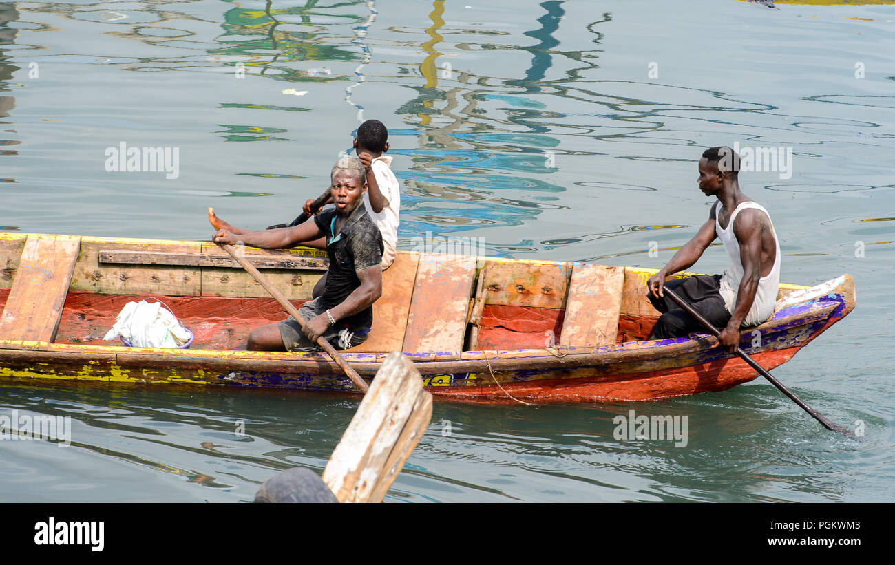ELMINA, GHANA -JAN 18, 2017: Unidentified Ghanaian men sail on the boat ...