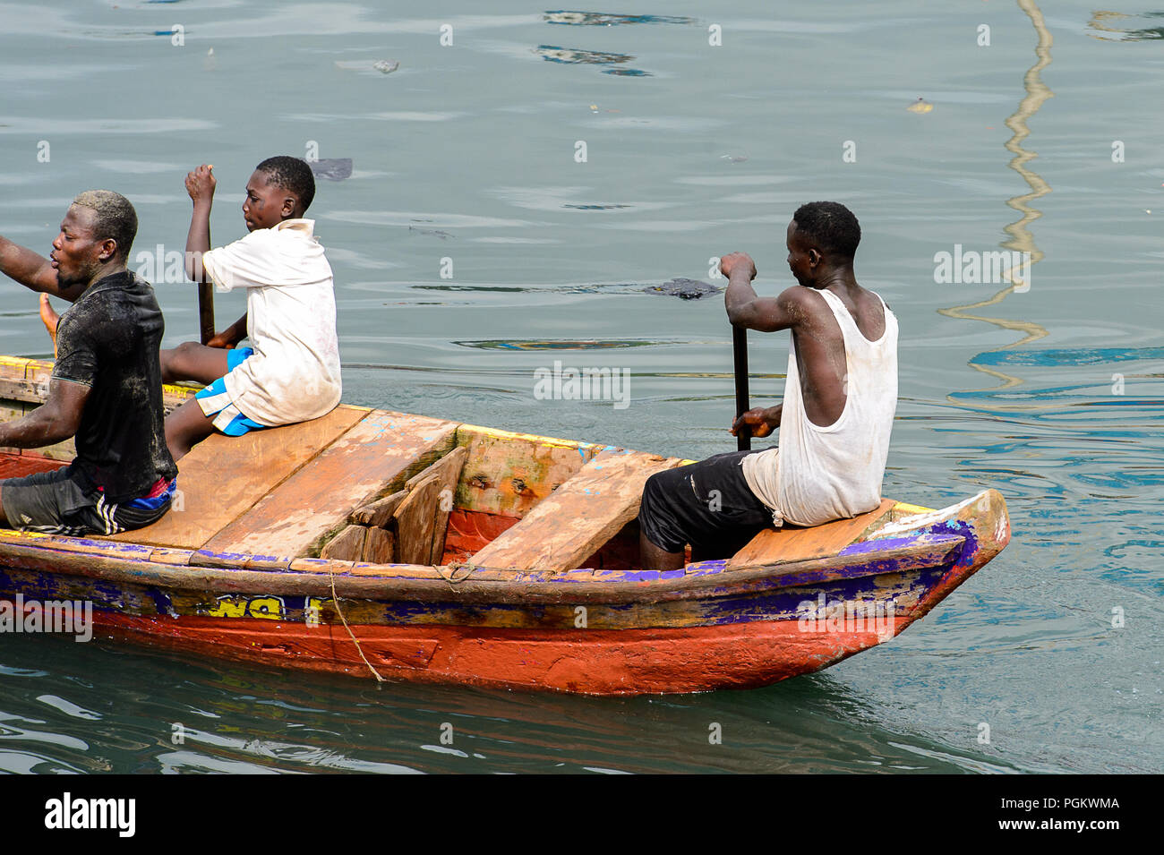 ELMINA, GHANA -JAN 18, 2017: Unidentified Ghanaian men sail on the boat ...
