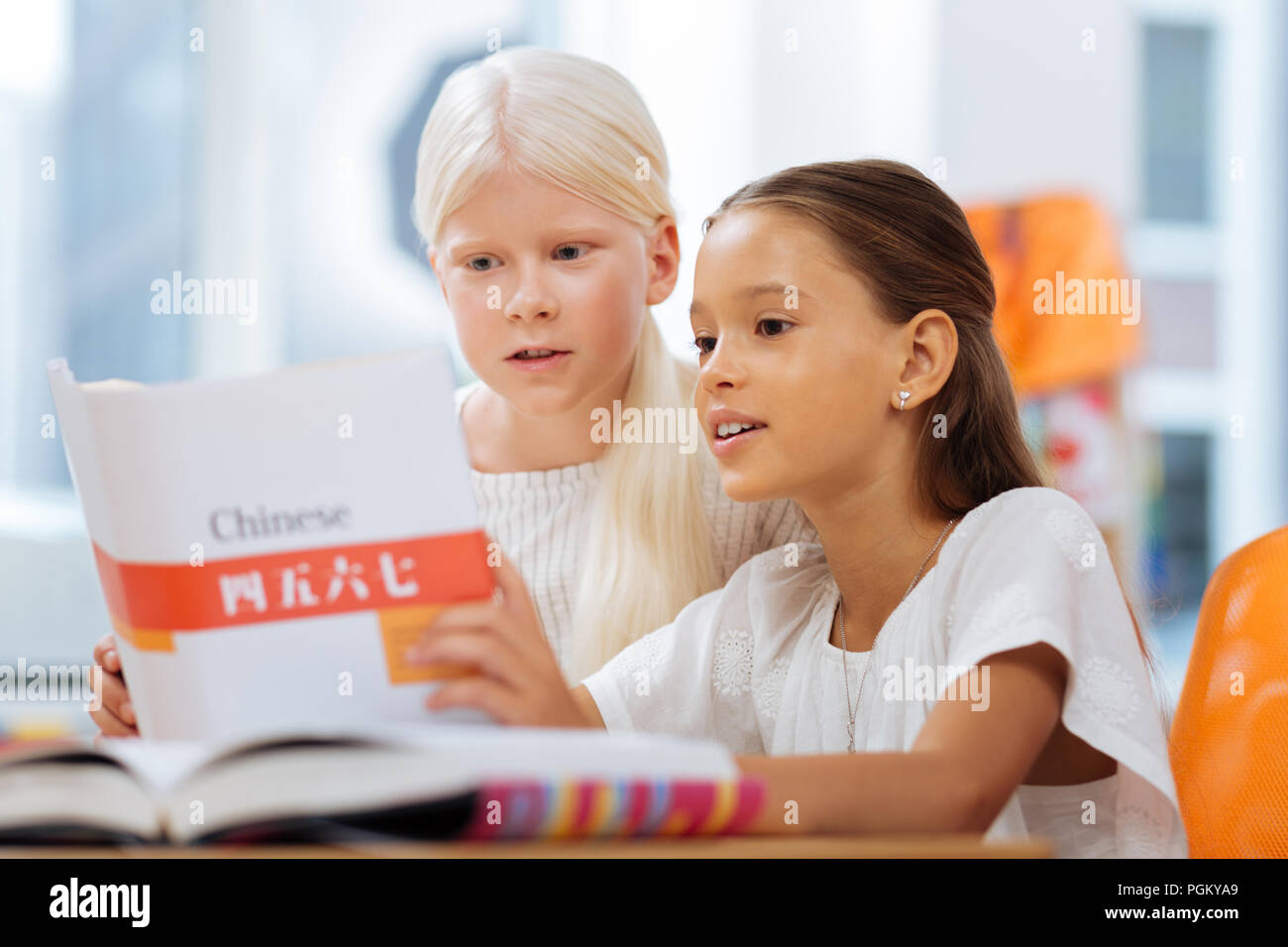 Cute friends doing homework at home together Stock Photo - Alamy