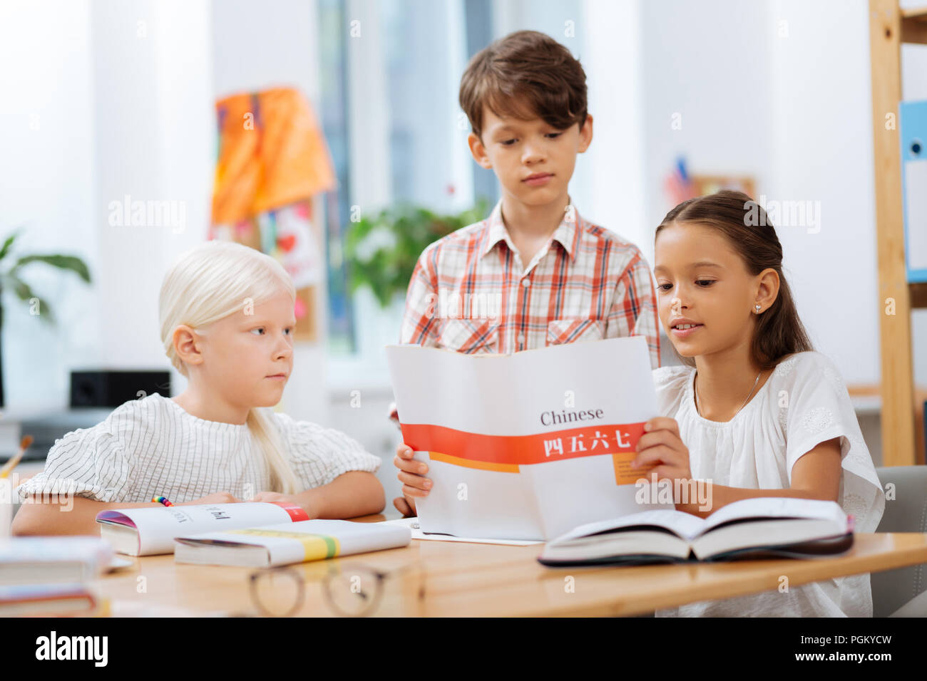 Concentrated children paying attention on details in an exercise Stock ...