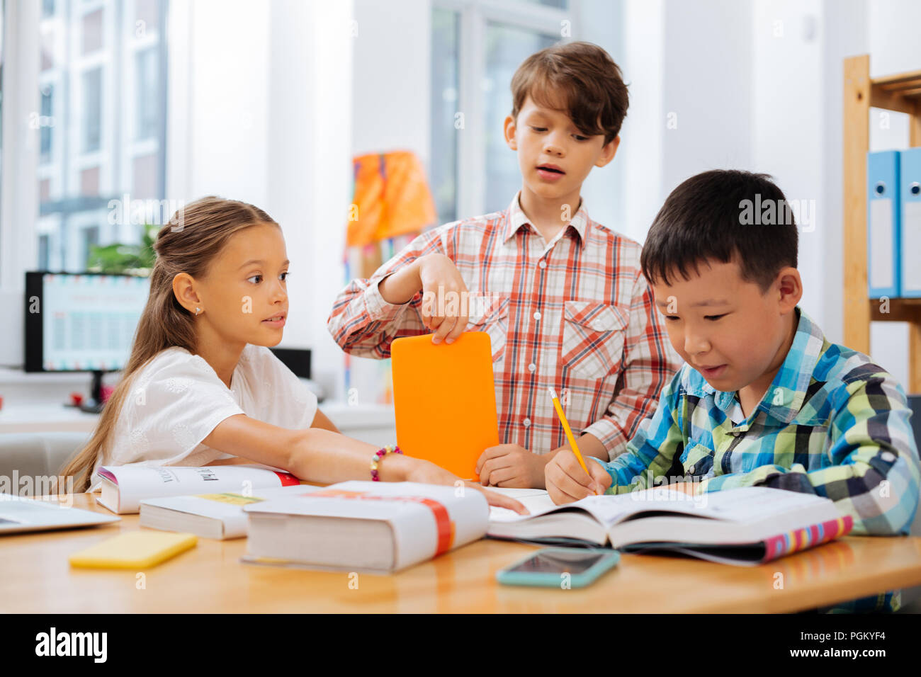 Funny kids doing their homework in a classroom Stock Photo - Alamy