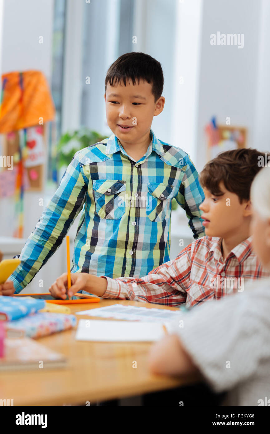 Confident smiling boy looking at the classmates Stock Photo - Alamy