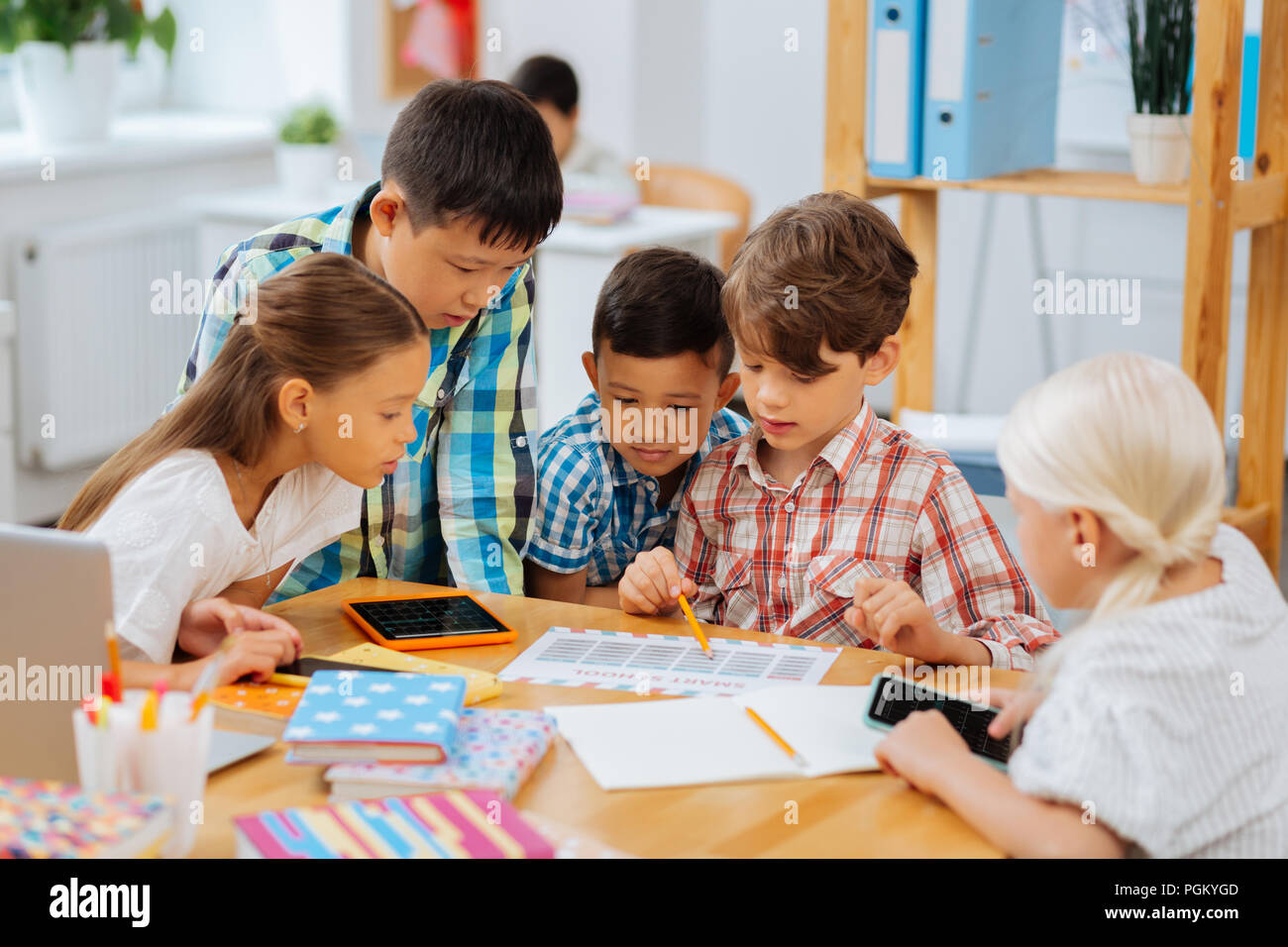 Company of classmates sitting together in a classroom Stock Photo - Alamy