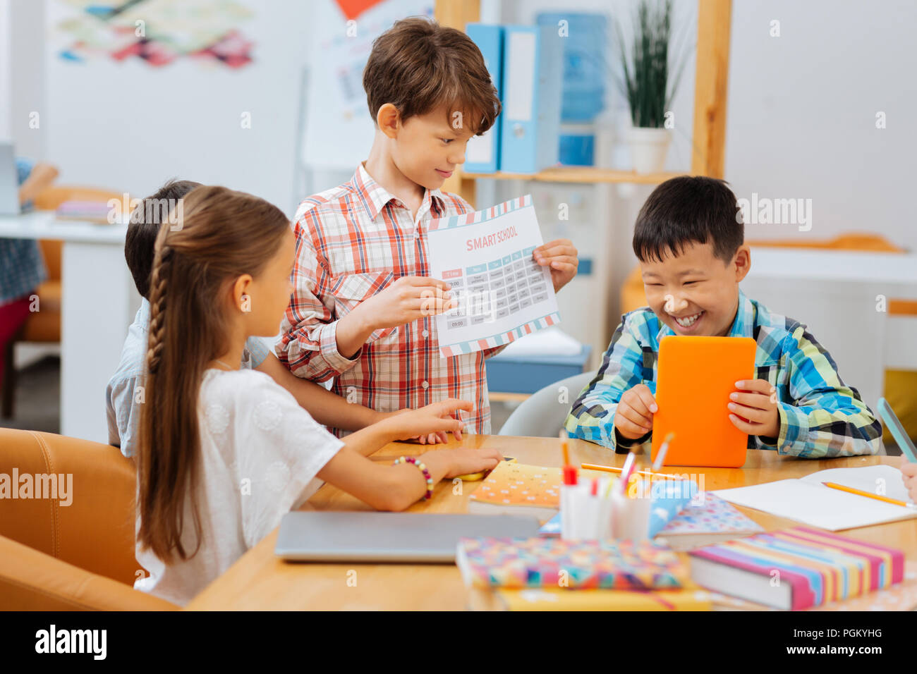 Cute boy looking at the mate attentively Stock Photo - Alamy