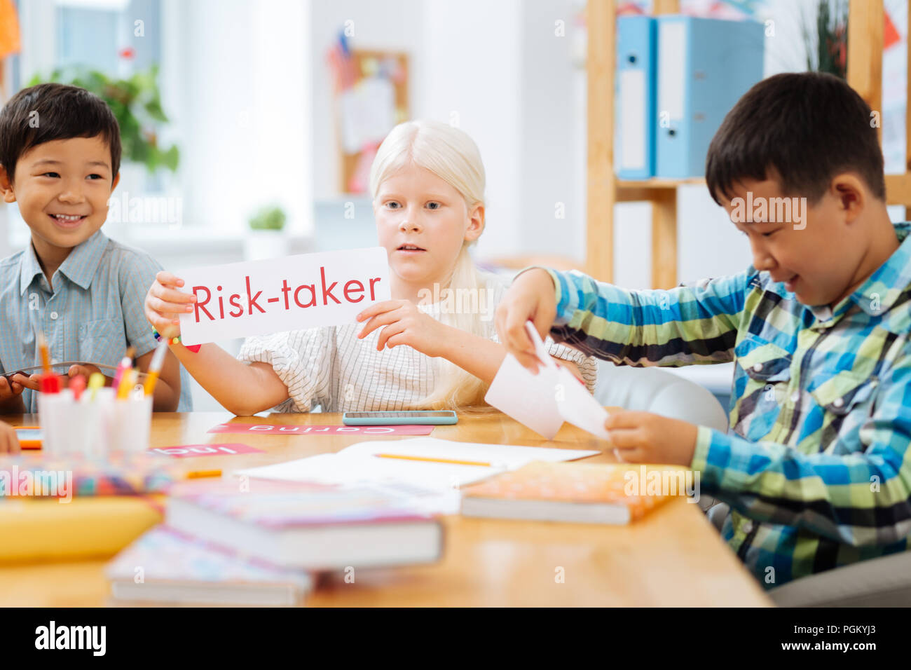 Pretty girl playing with the classmates at school Stock Photo - Alamy