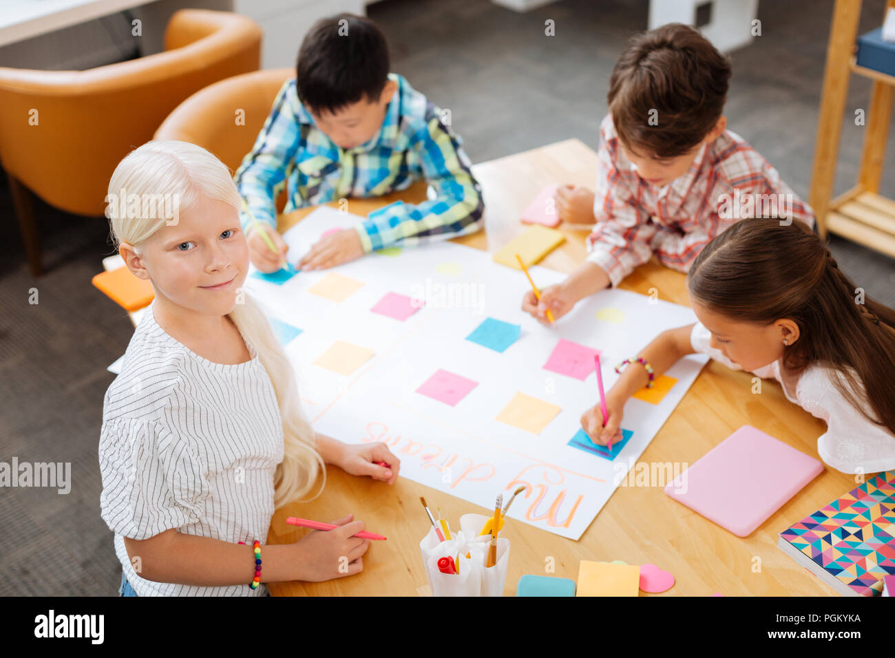 Pretty girl spending time with classmates at school Stock Photo - Alamy