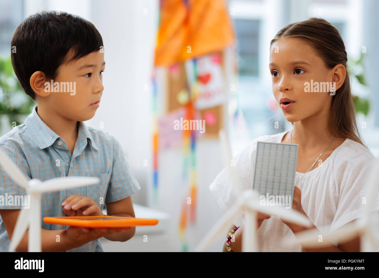 Boy and girl speaking in a classroom Stock Photo - Alamy