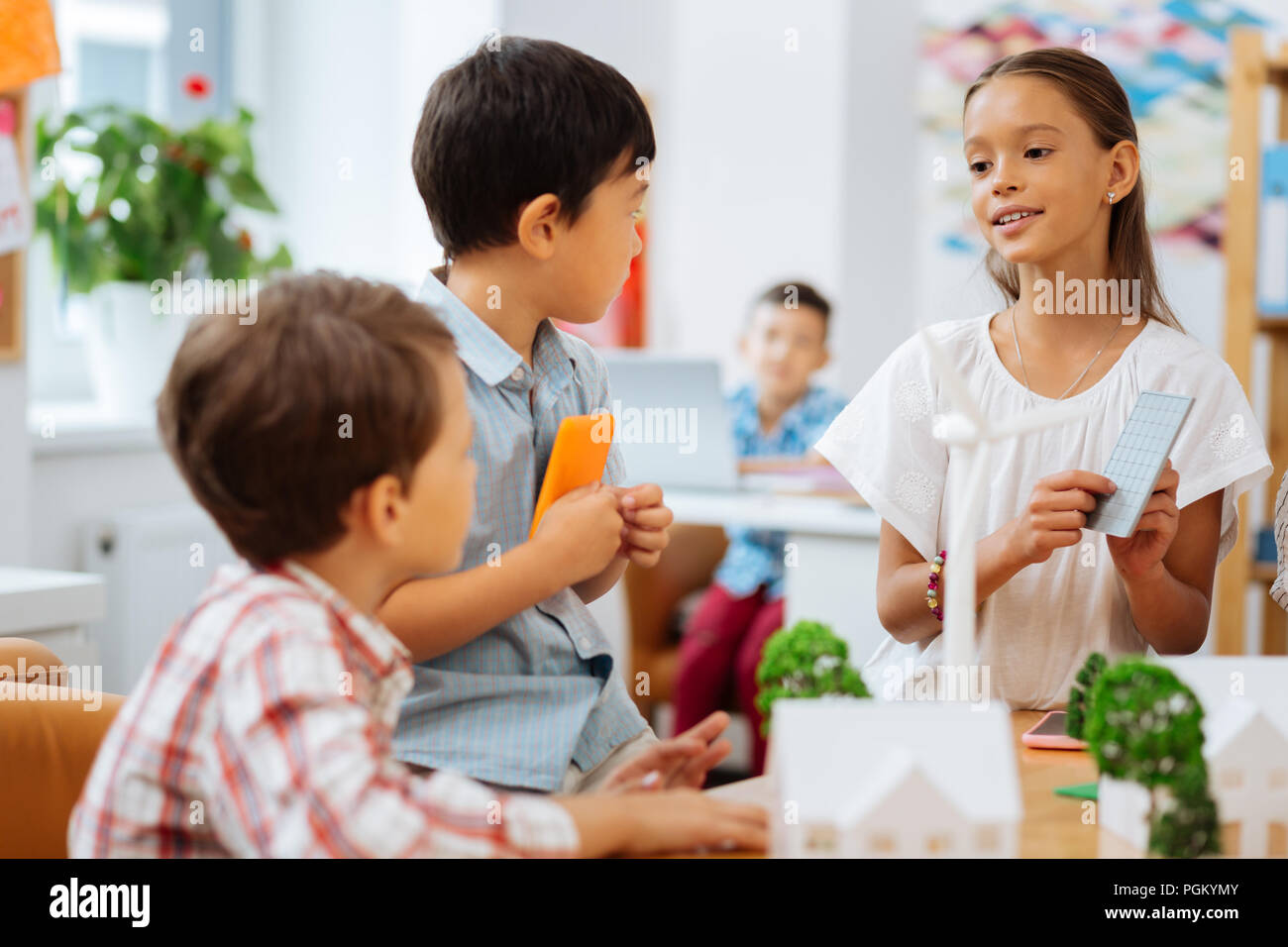 Pretty girl speaking with mates in a class Stock Photo - Alamy