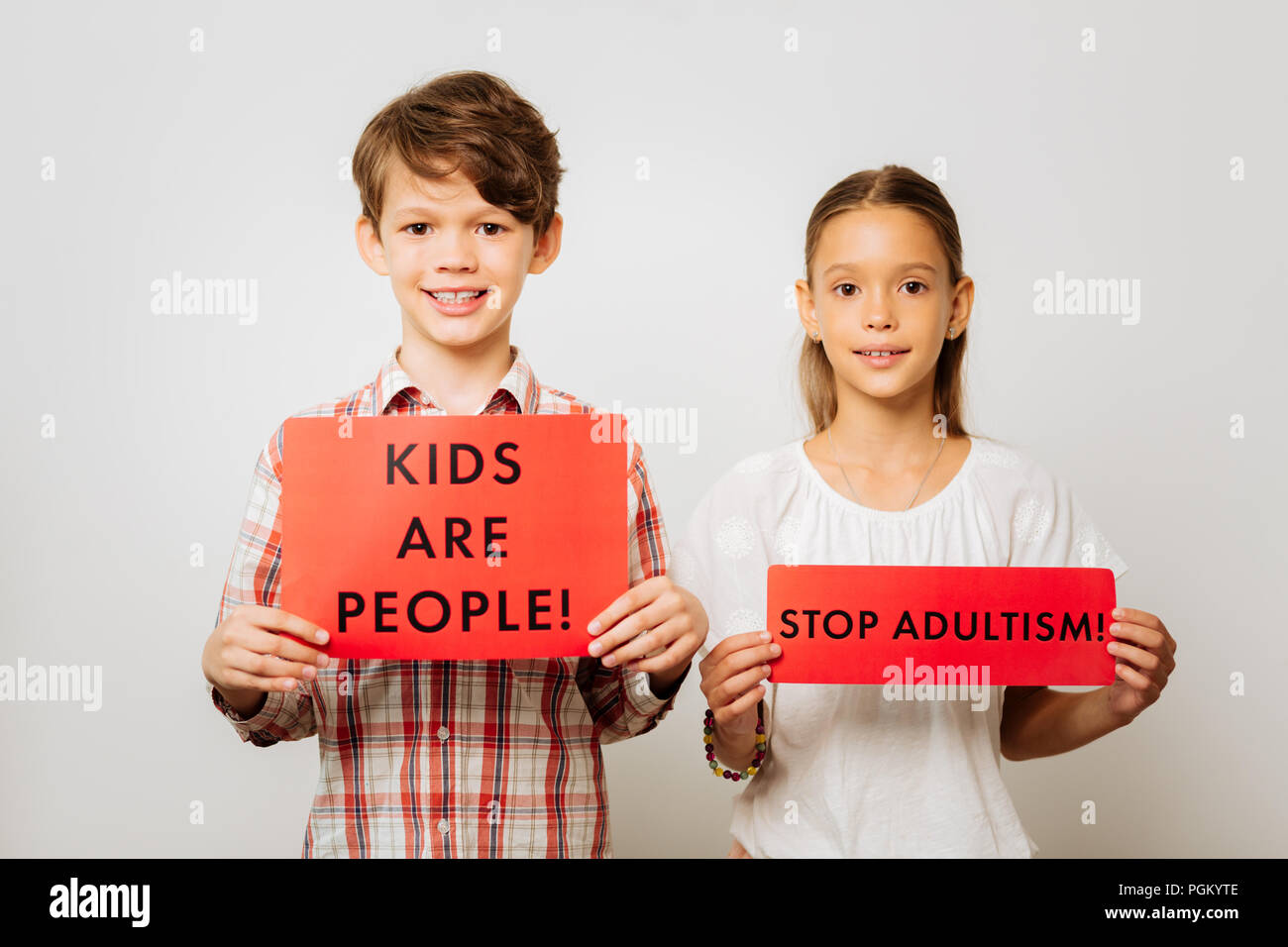 Cute kids holding tables in their hands Stock Photo - Alamy